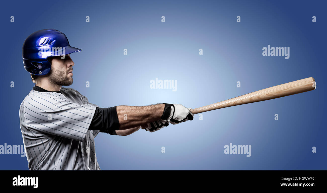 Baseball Player on a Blue Uniform on blue background Stock Photo - Alamy