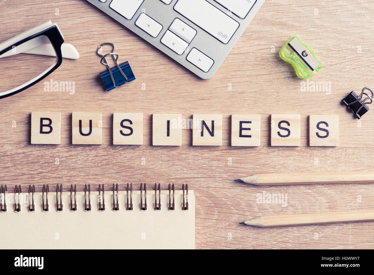 Elements of game with letters spelling business keywords on workplace ...