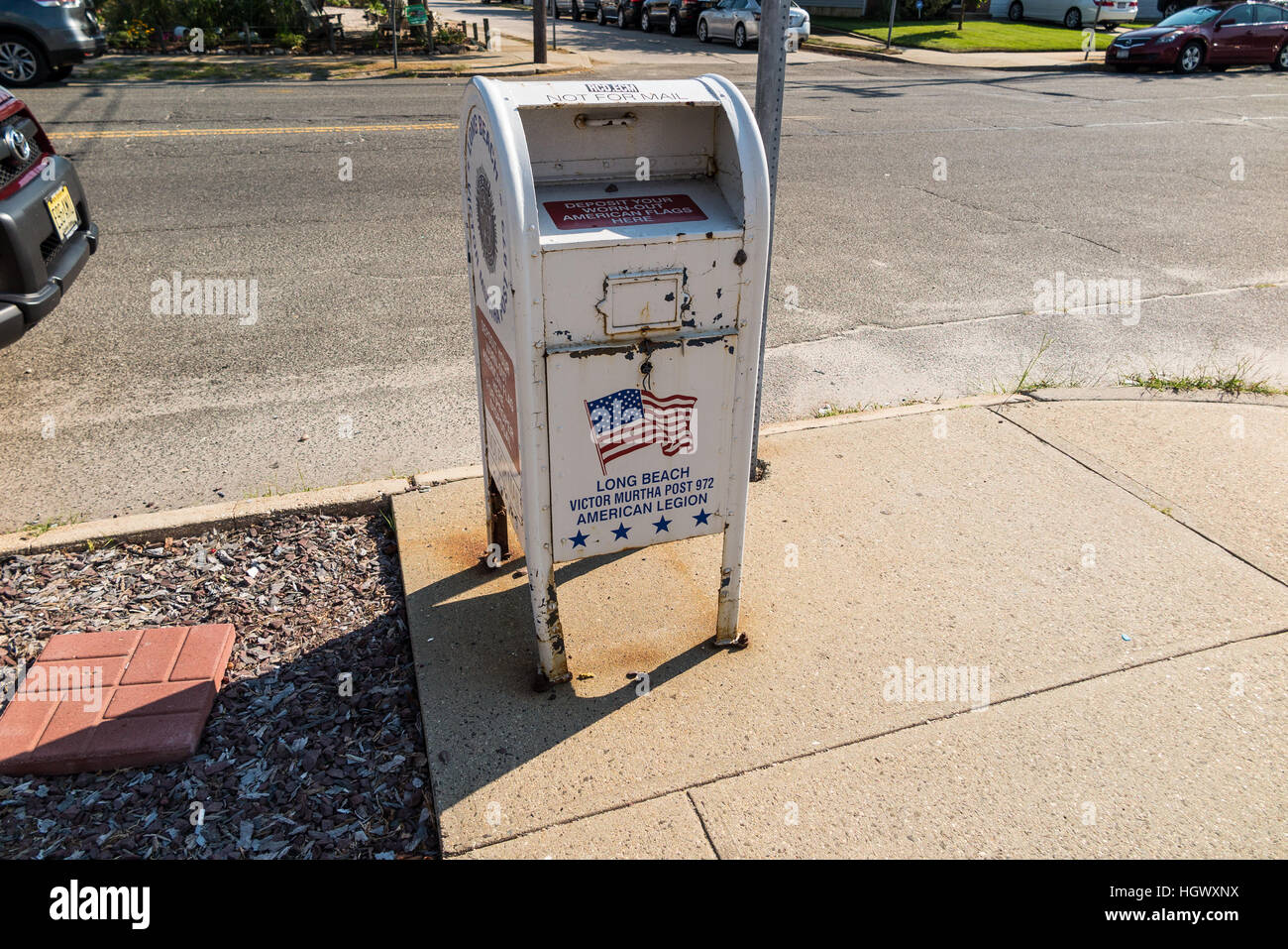 Worn flag deposit box on the sidewalk Stock Photo - Alamy