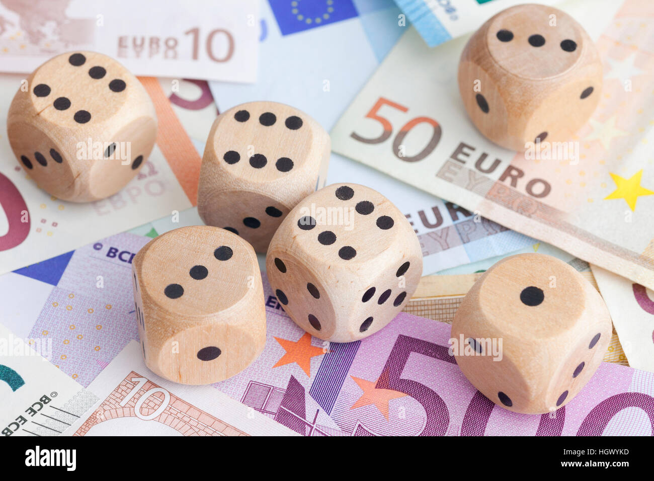 Euro banknotes and wooden dice on them. Concept image. Close up Stock ...
