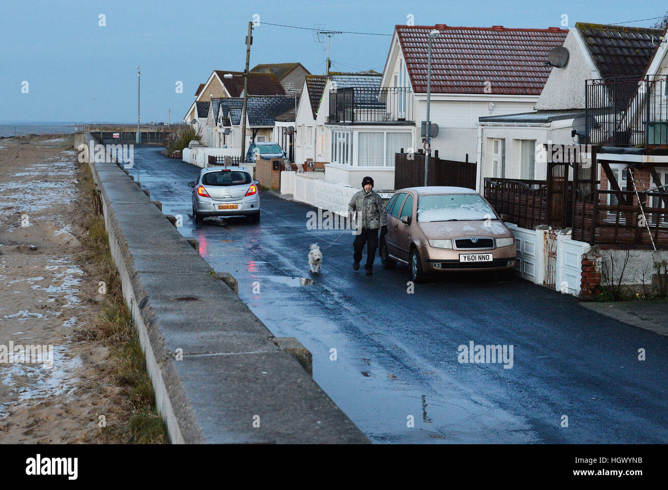 A resident walks his dog along Brooklands Road in Jaywick, Essex, from ...