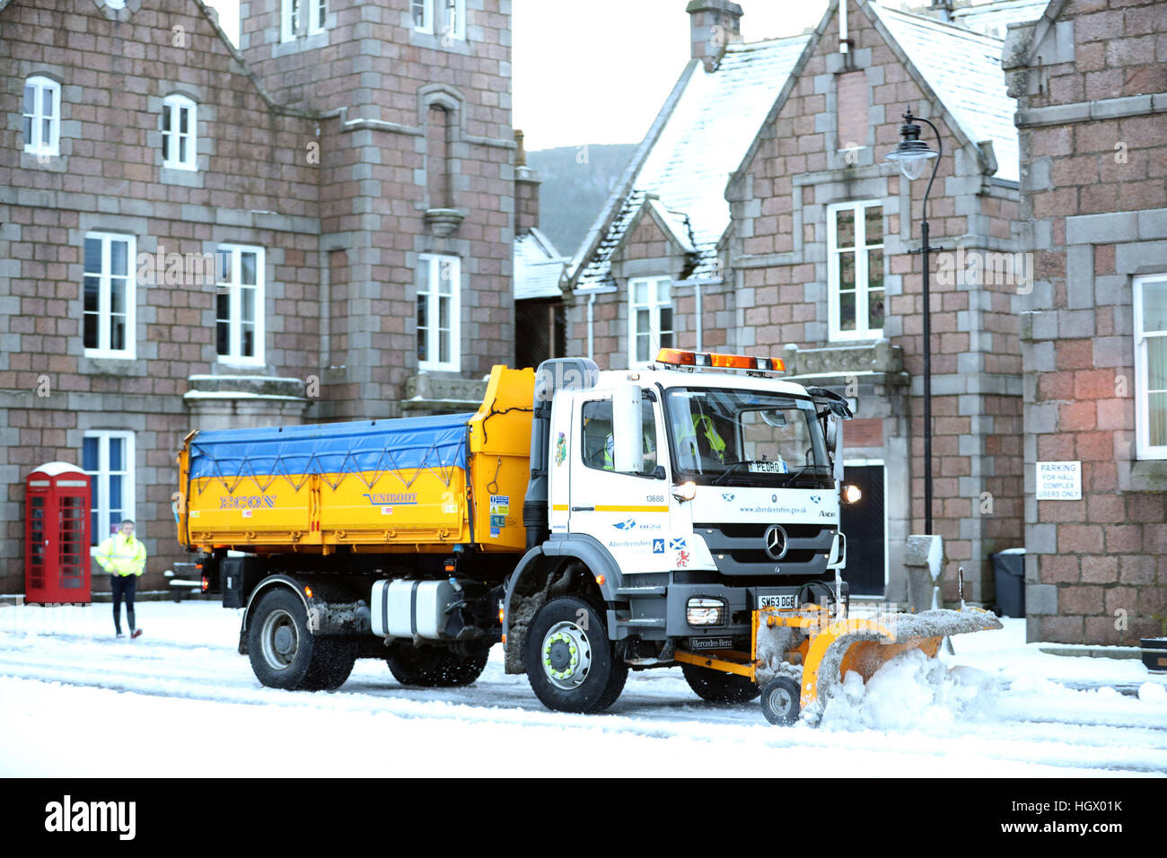 A snow plough clears the road in the centre of Ballater, Aberdeenshire ...