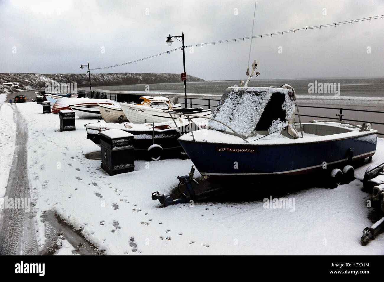 Boats covered in snow at Filey on the East coast, as Scotland and the ...