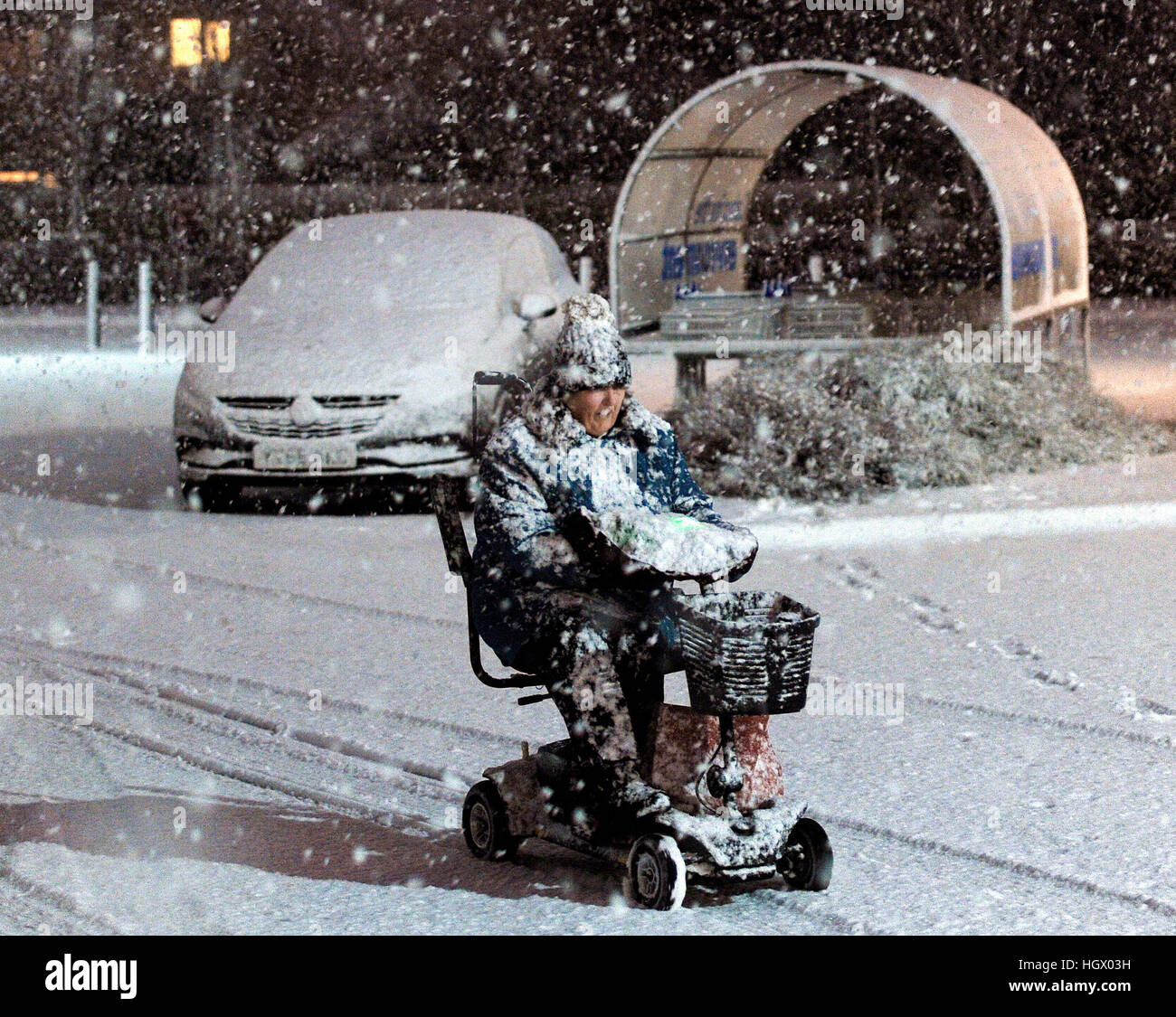 A lady makes her way through the snow on a mobility scooter in Filey on ...