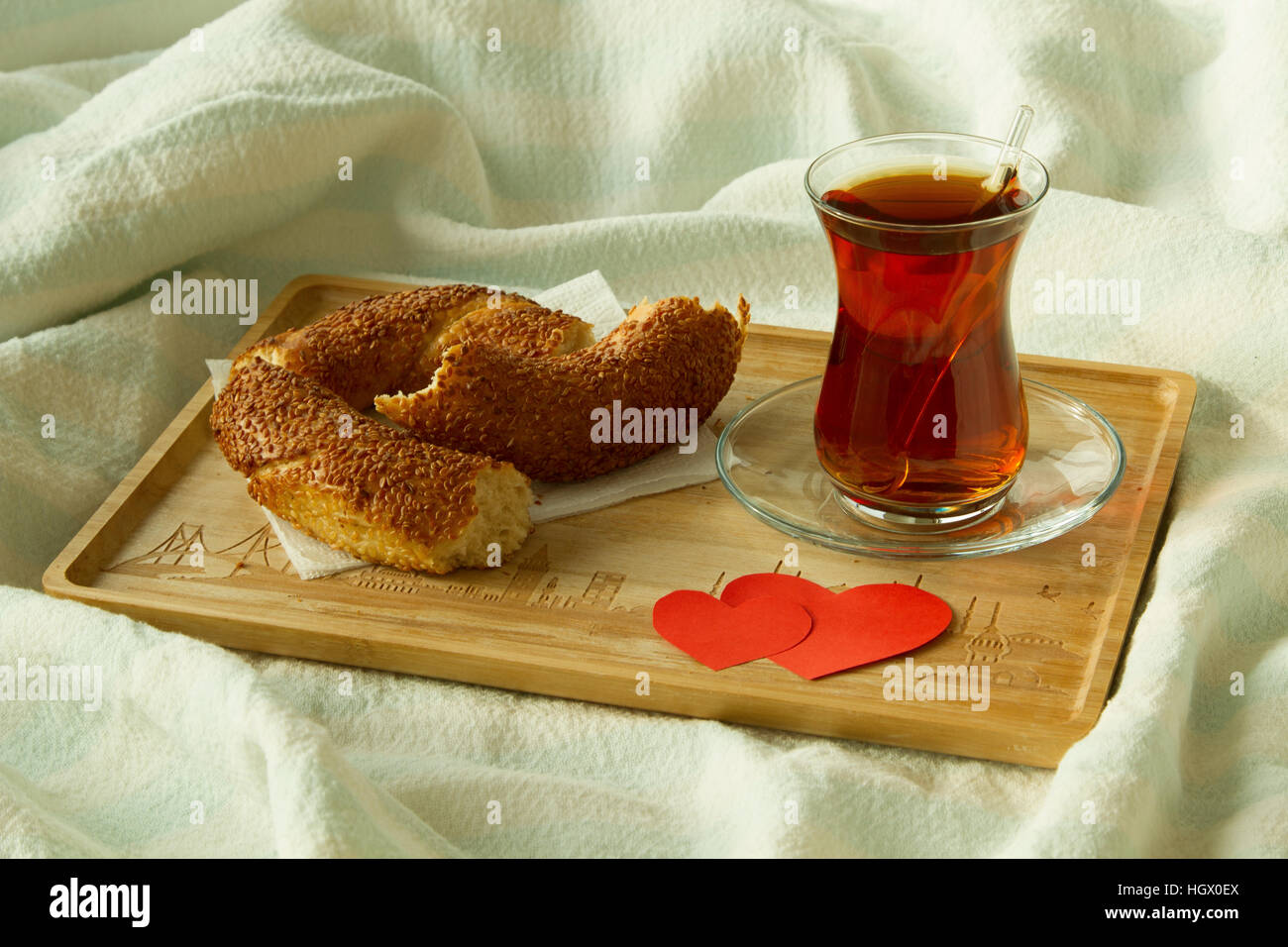 Morning turkish tea in traditional glass with bagel on the tray ...