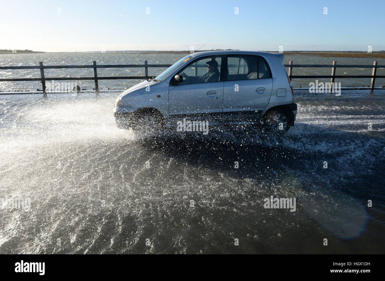 A car crosses The Strood causeway in Essex as Mersea Island prepares ...