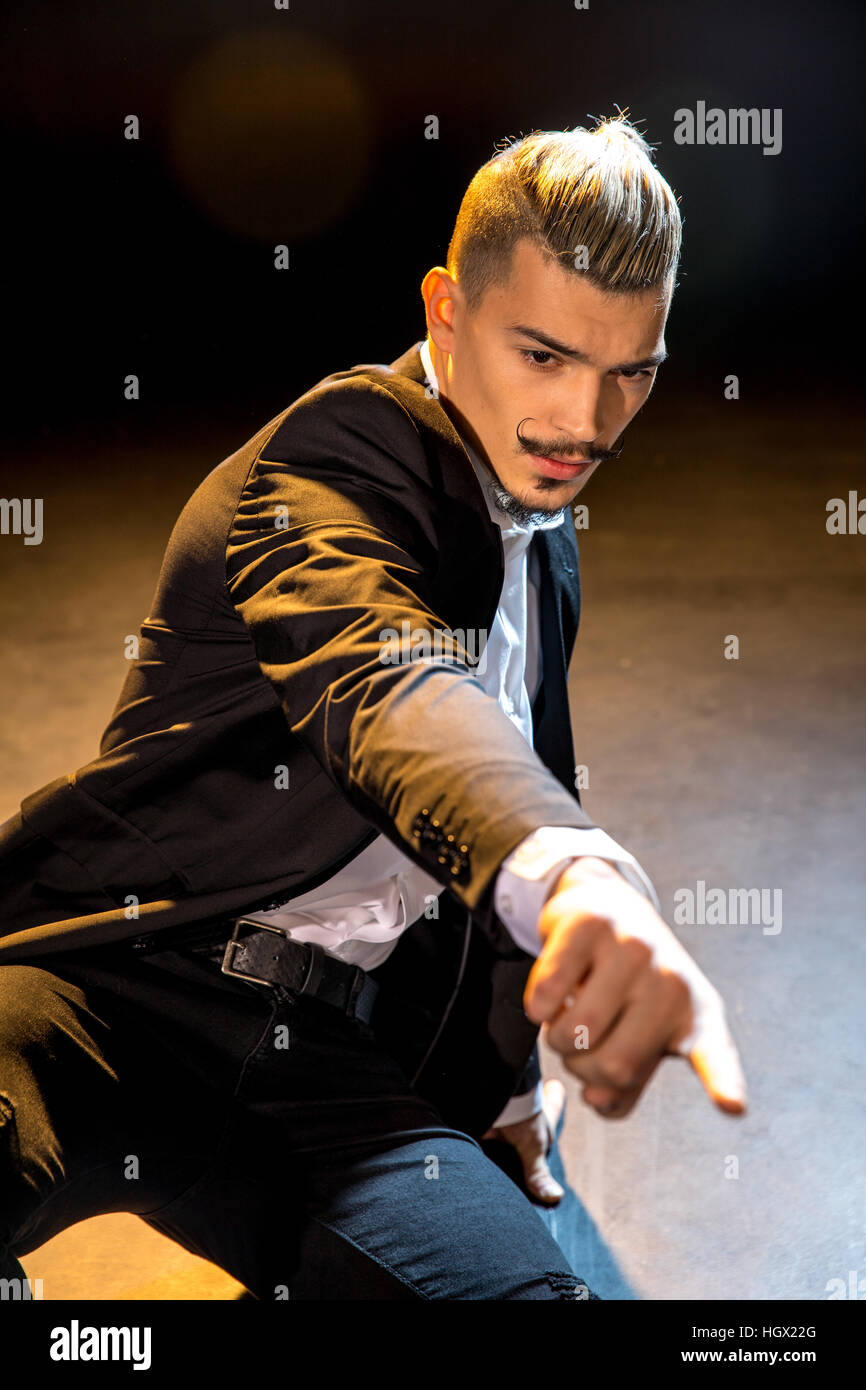 Handsome young man in suit dancing on floor Stock Photo - Alamy