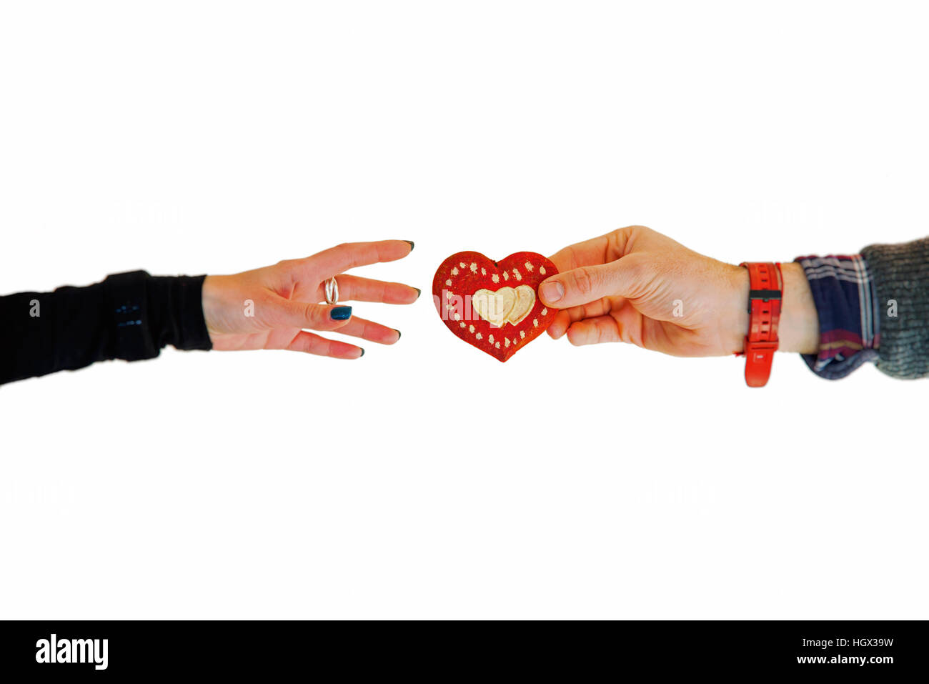 Man's hand gives an heart to a woman's hand on white background Stock ...