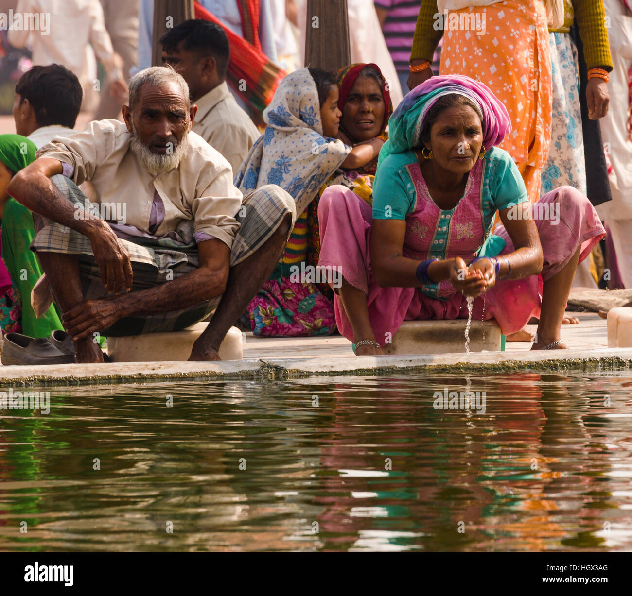 Muslim Man and Woman bathing at India's largest mosque, the Jami Masjid ...