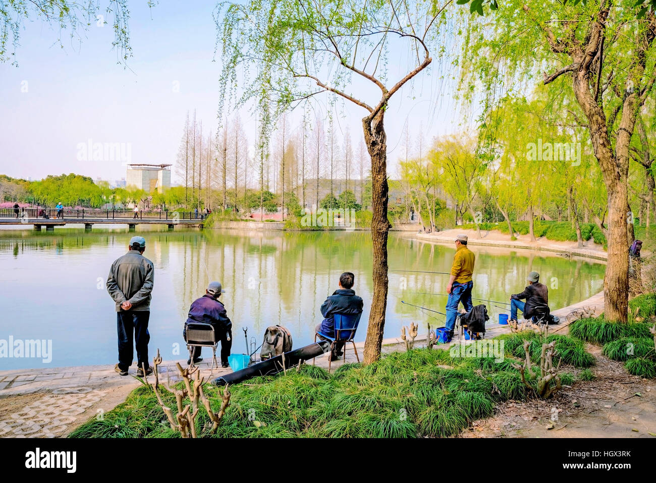 chinese people fishing on a lake in a park in Shanghai Stock Photo - Alamy