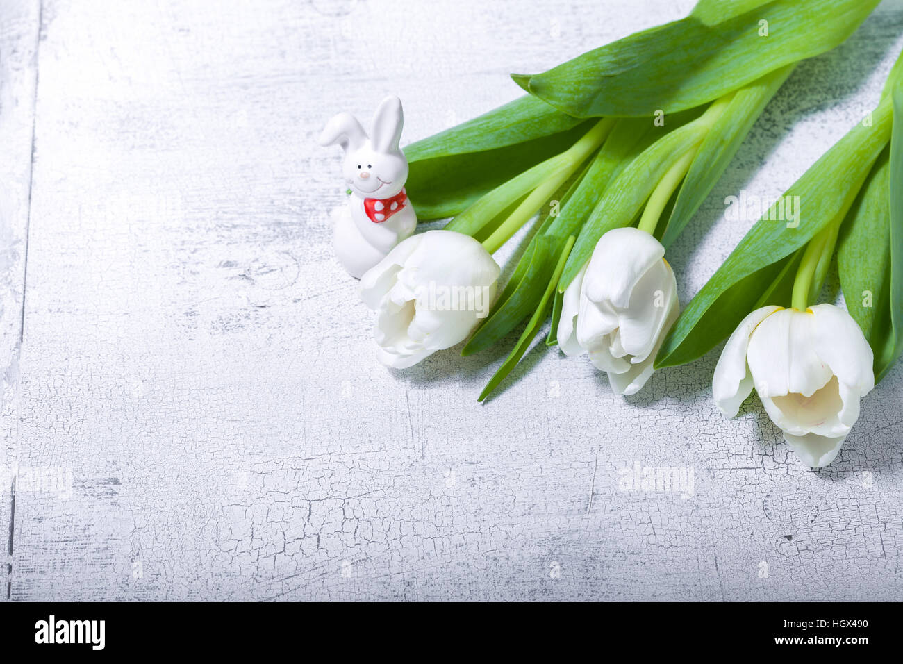 White tulips and and bunny on wooden table Stock Photo - Alamy