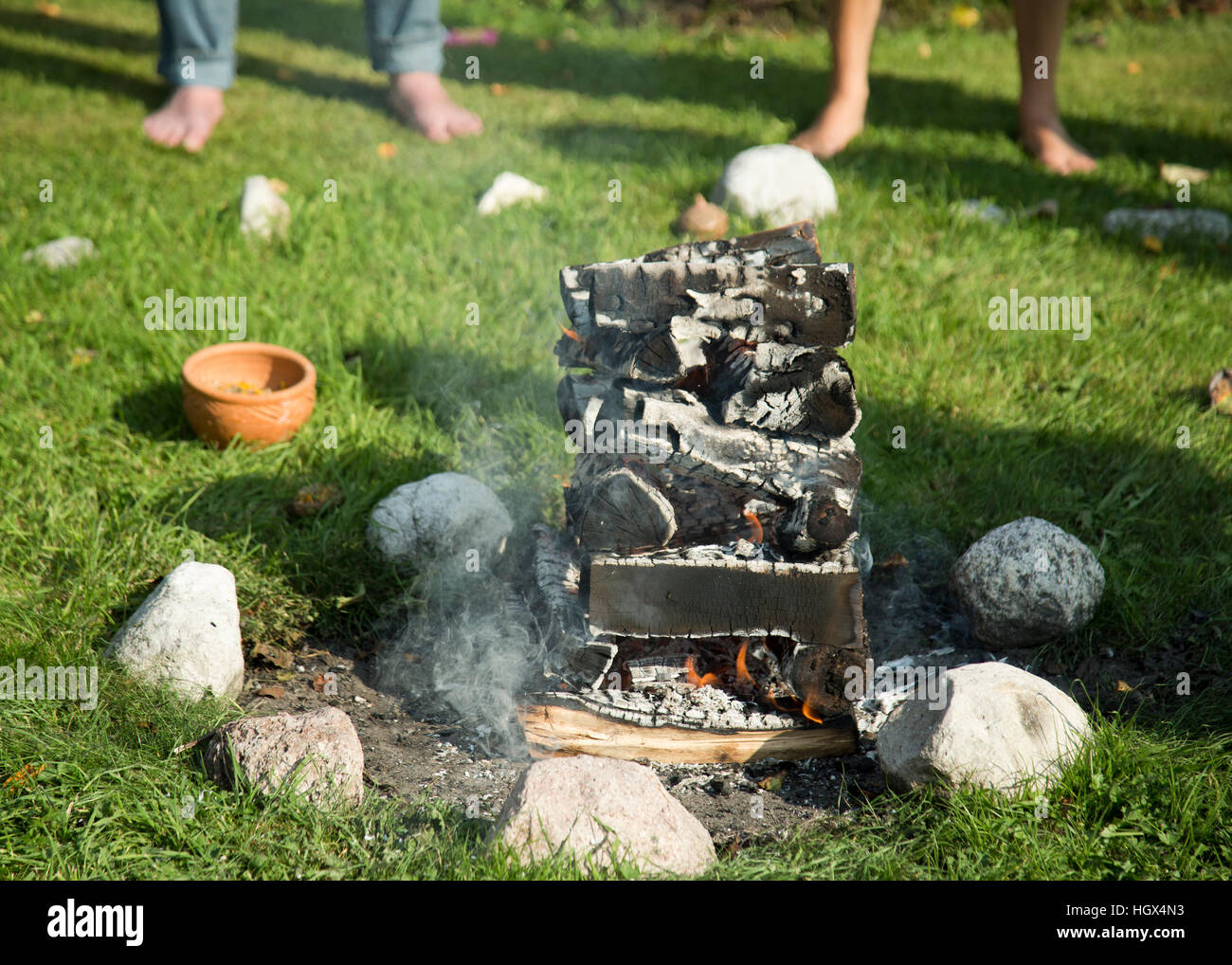 Close up burning campfire in smoking wood stack, in background out of ...