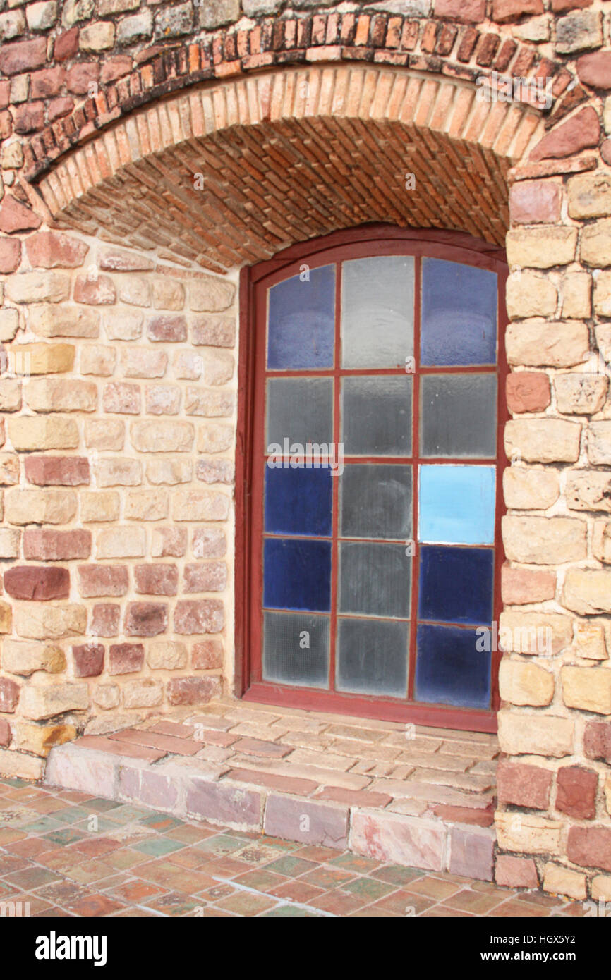 Antique blue-squared stained glass window set in brick Stock Photo - Alamy