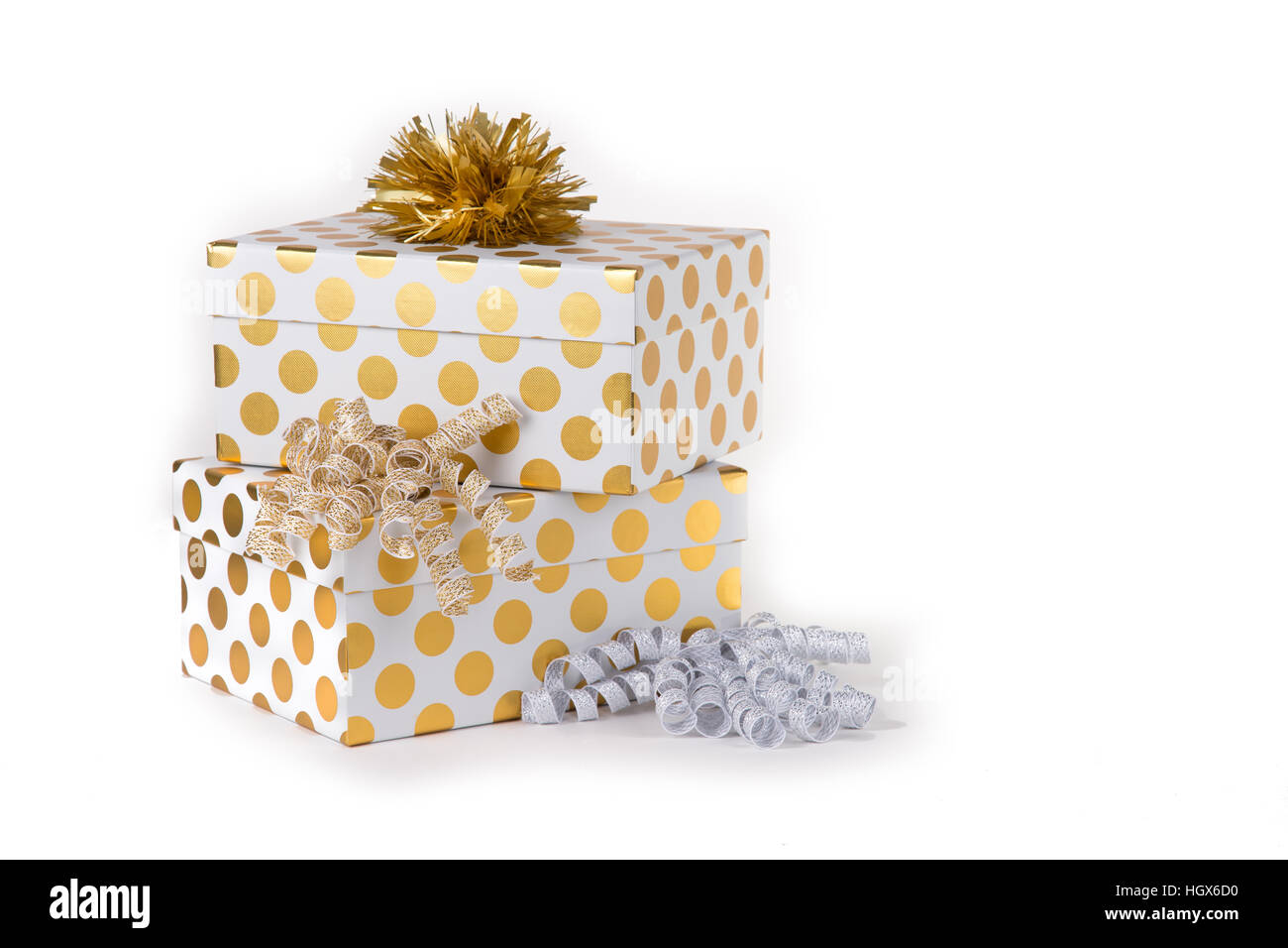 Polka dot gift boxes in gold and white with ribbons Stock Photo - Alamy