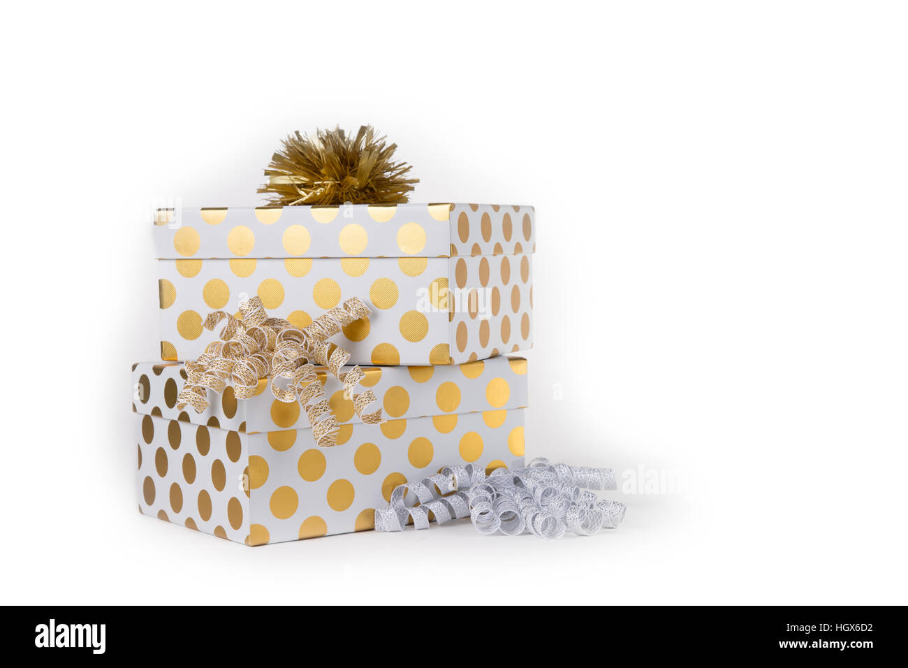 Polka dot gift boxes in gold and white with ribbons Stock Photo - Alamy