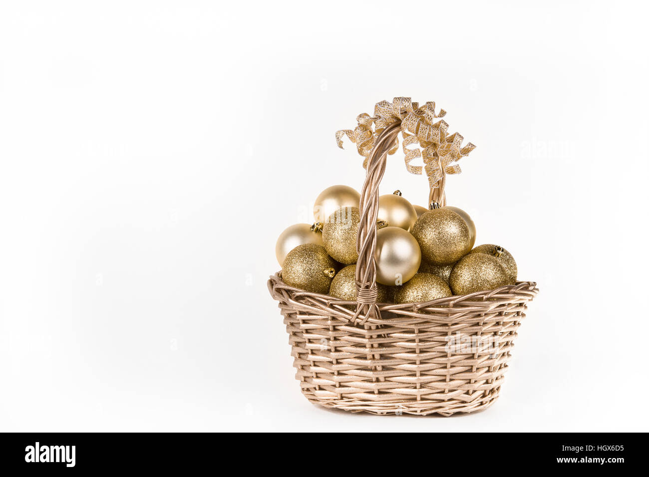 Gold wicker basket with gold balls and ribbons Stock Photo - Alamy