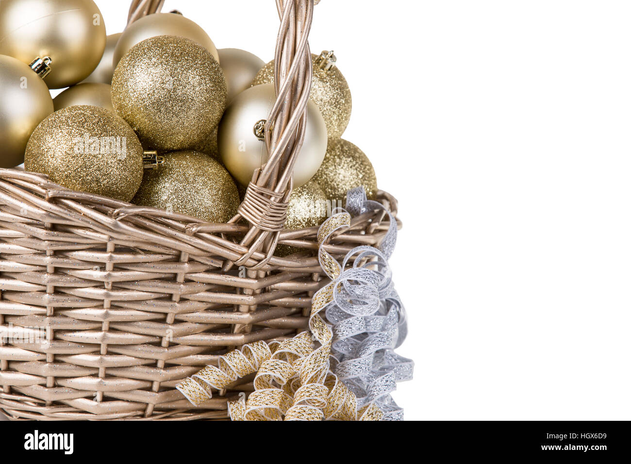 Gold wicker basket with gold balls and ribbons Stock Photo - Alamy