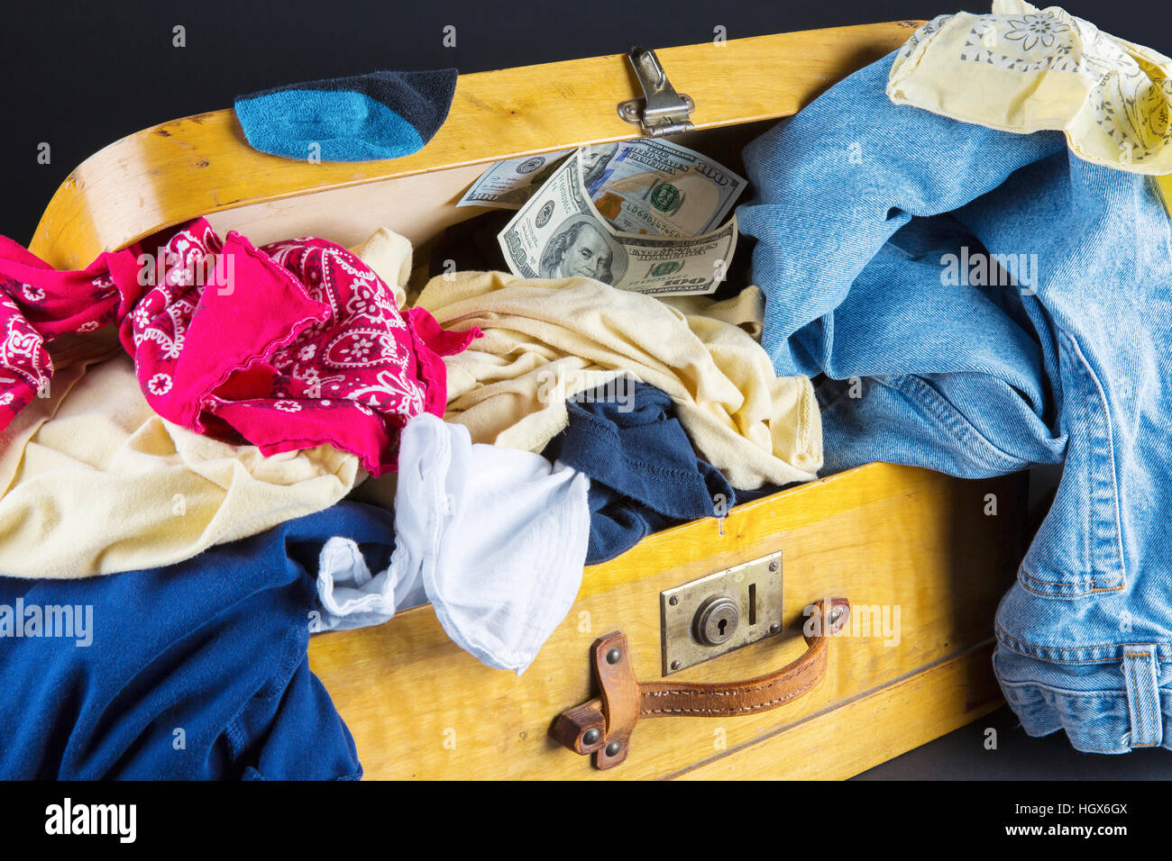 Vintage suitcase and old clothes Stock Photo - Alamy