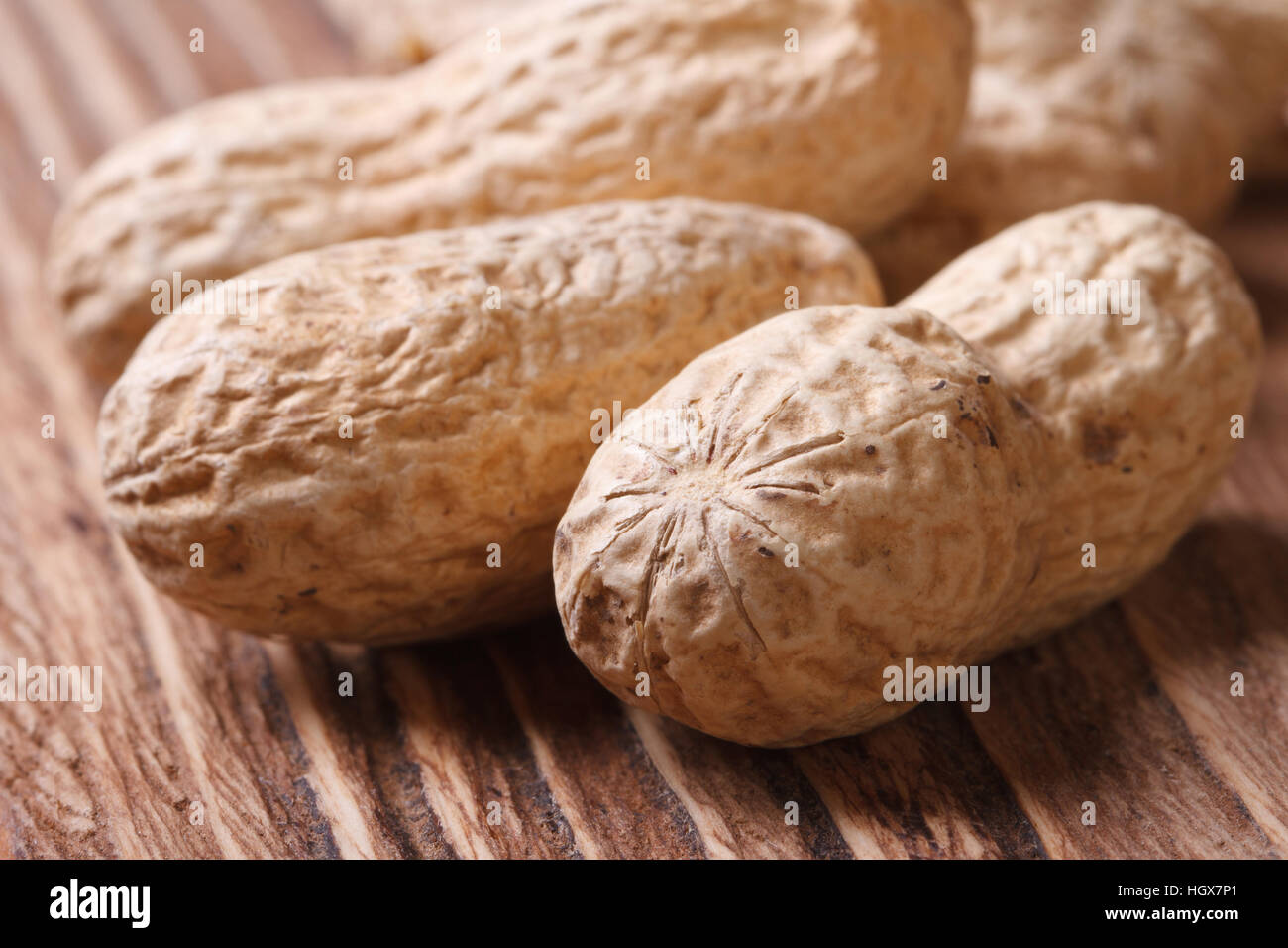 peanuts in shell closeup on a wooden table. macro texture Stock Photo ...