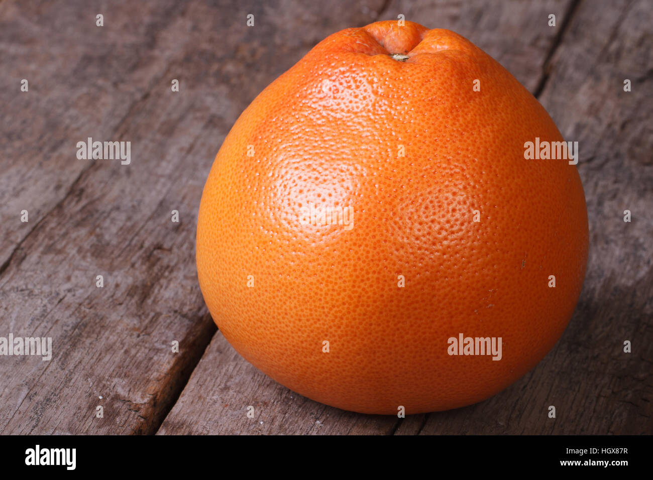 Ripe grapefruit close-up on an old table. peel texture Stock Photo - Alamy