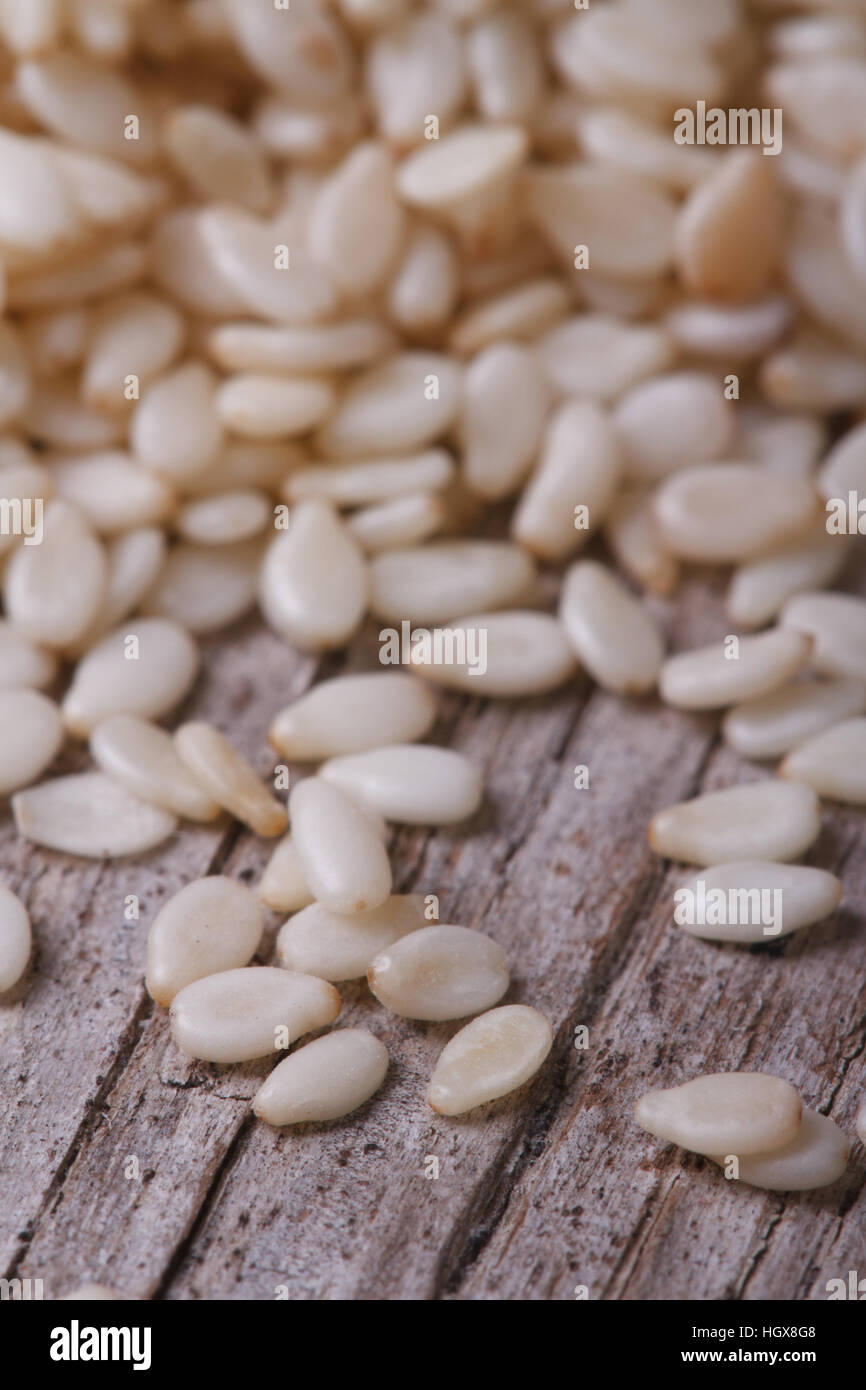 Sesame seeds scattered on an old wooden table. macro. vertical Stock ...
