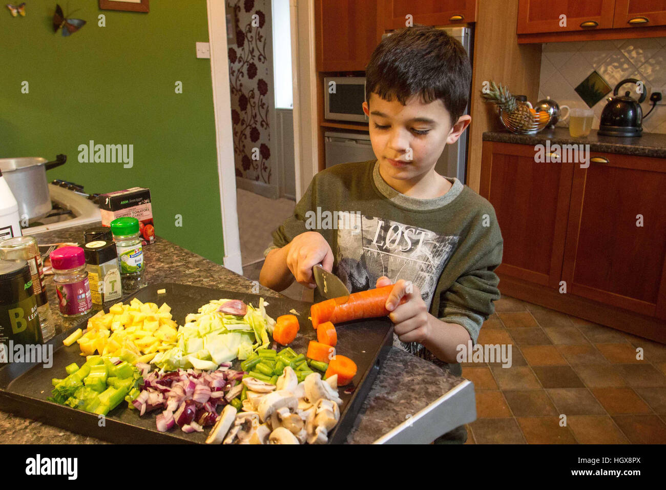 Young boy cooking healthy meal Stock Photo - Alamy