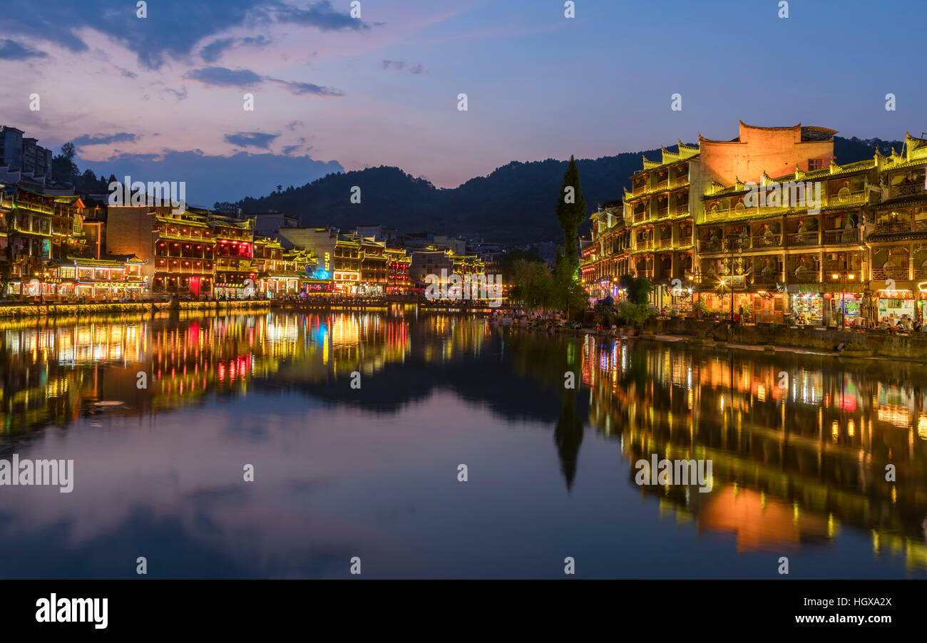 Lights lit the traditional buildings of Fenghuang Ancient Town by the ...
