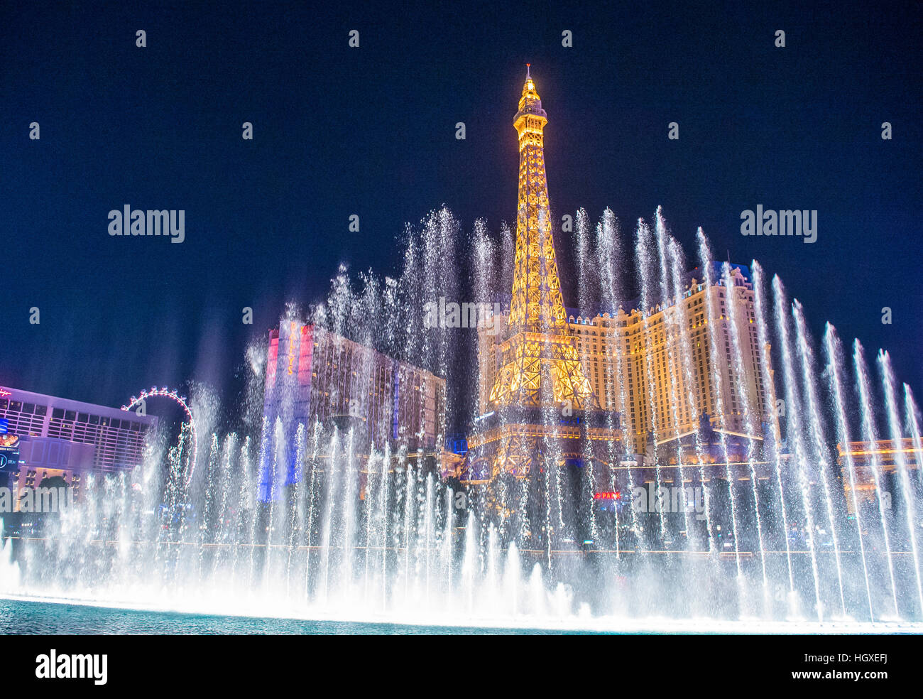 LAS VEGAS - OCT 05 : Night view of the dancing fountains of Bellagio and the Eiffel Tower ...