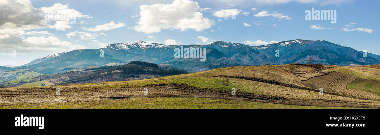 Early spring highland landscape. Panorama of rural fields on hill side ...