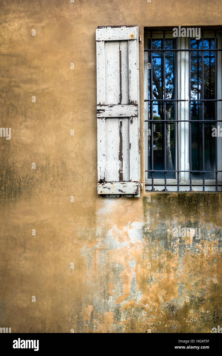 Decorative grungy window on an old sienna stucco wall Stock Photo - Alamy