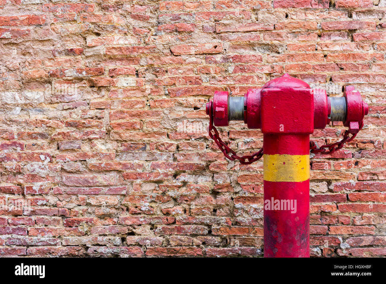 Fire Hydrant at the Weathered stained old dark brown Wall, Dirty Brick ...
