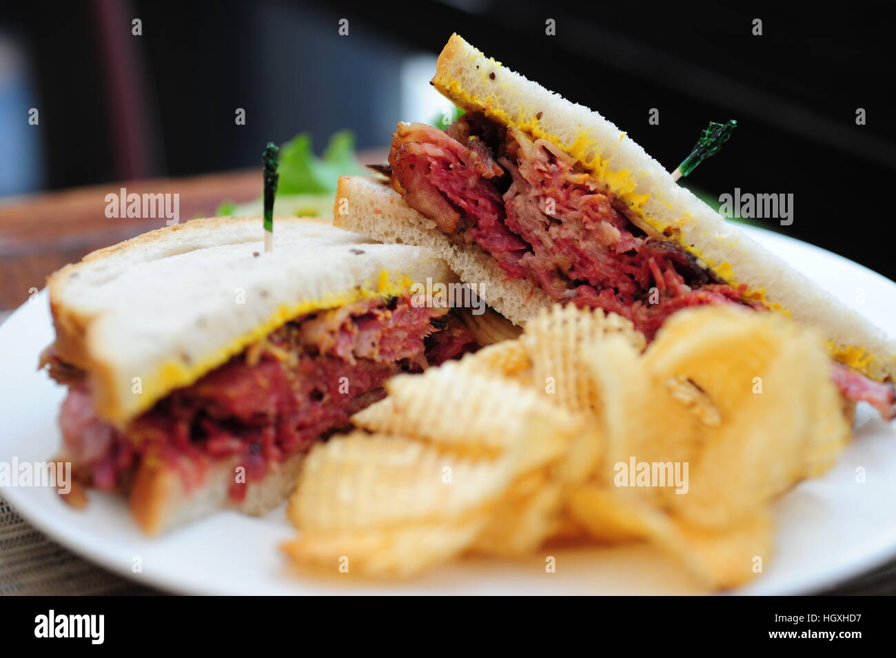 Corned beef on rye bread sandwich with potato chips Jewish deli ...
