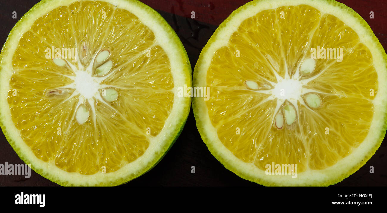 Close up of sliced Lemons with wooden background Stock Photo - Alamy
