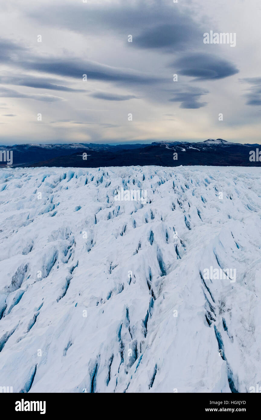 Pressure ridges and crevasse scar the surface of a glacier on the ...