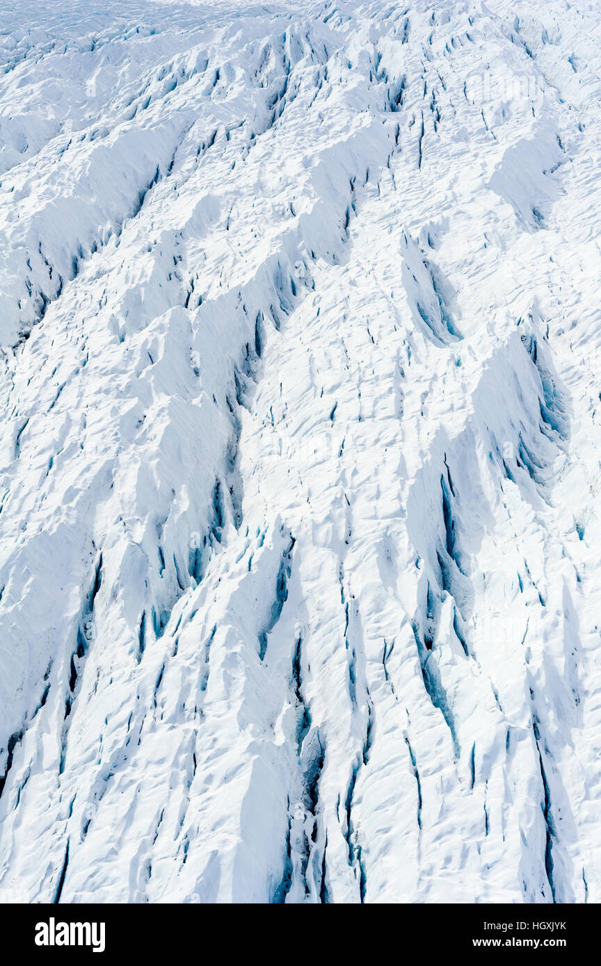 Pressure ridges and crevasse scar the surface of a glacier on the ...