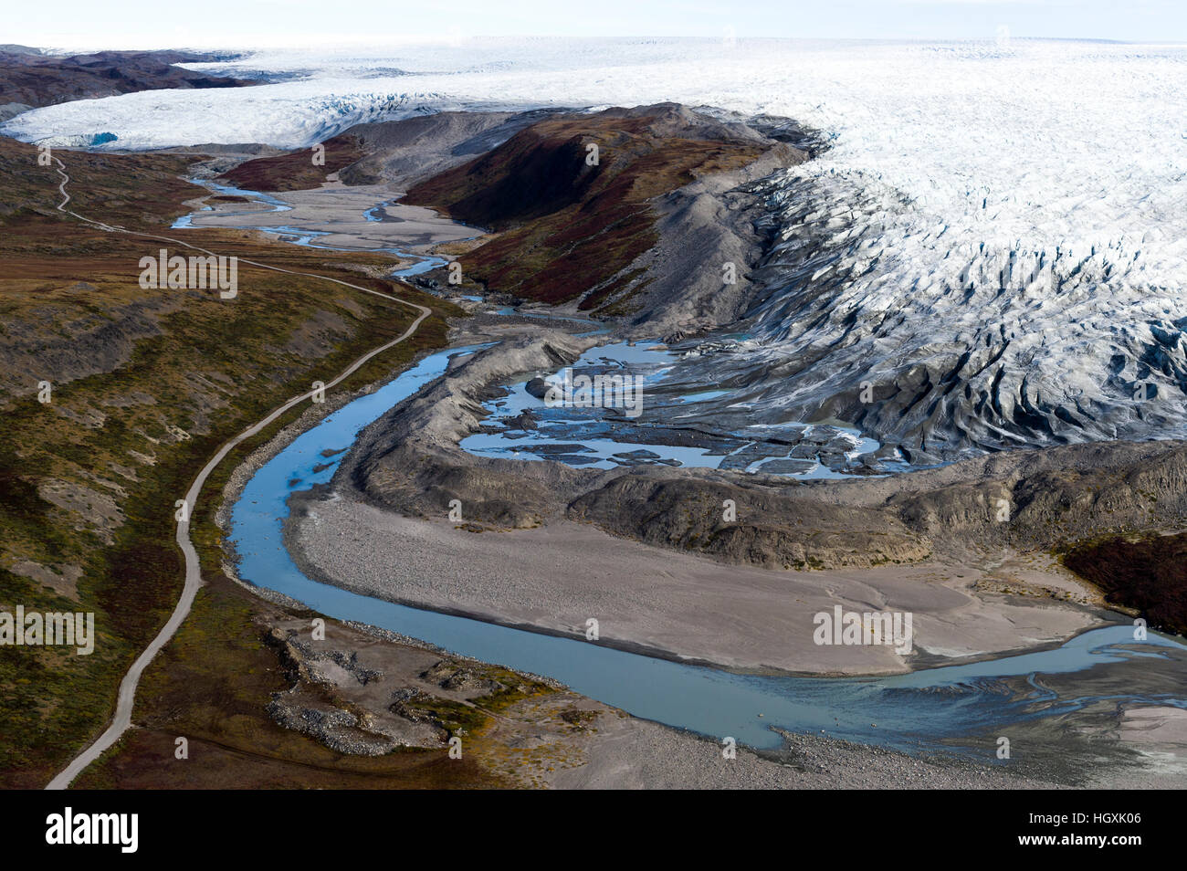 A river skirts a pile of rock, sediment and silt debris deposited by ...