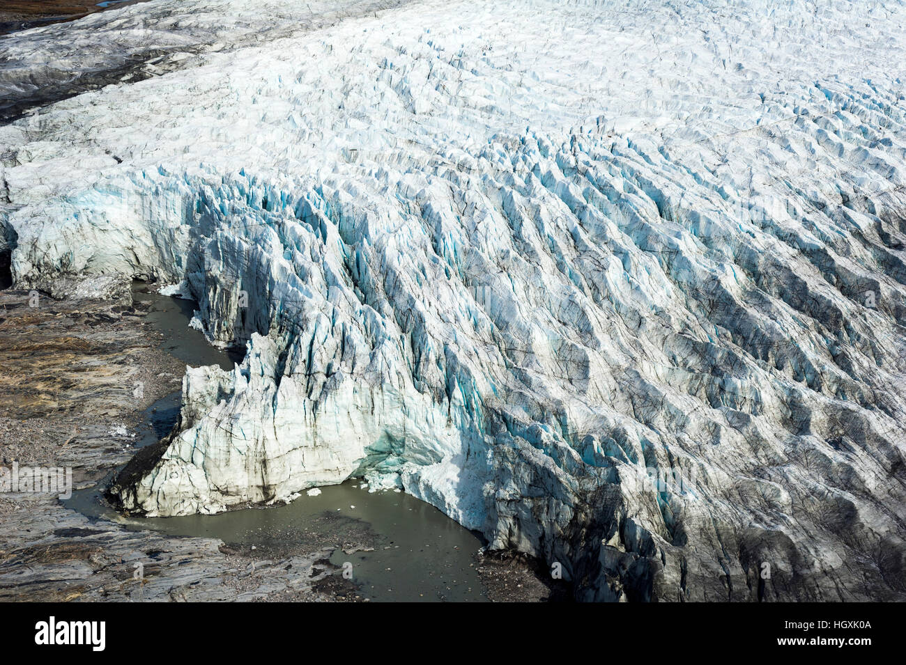 Pressure ridges and crevasse scar the surface of a glacier on the ...