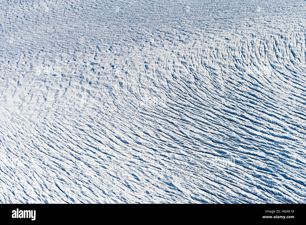 Pressure ridges and crevasse scar the surface of a glacier on the ...