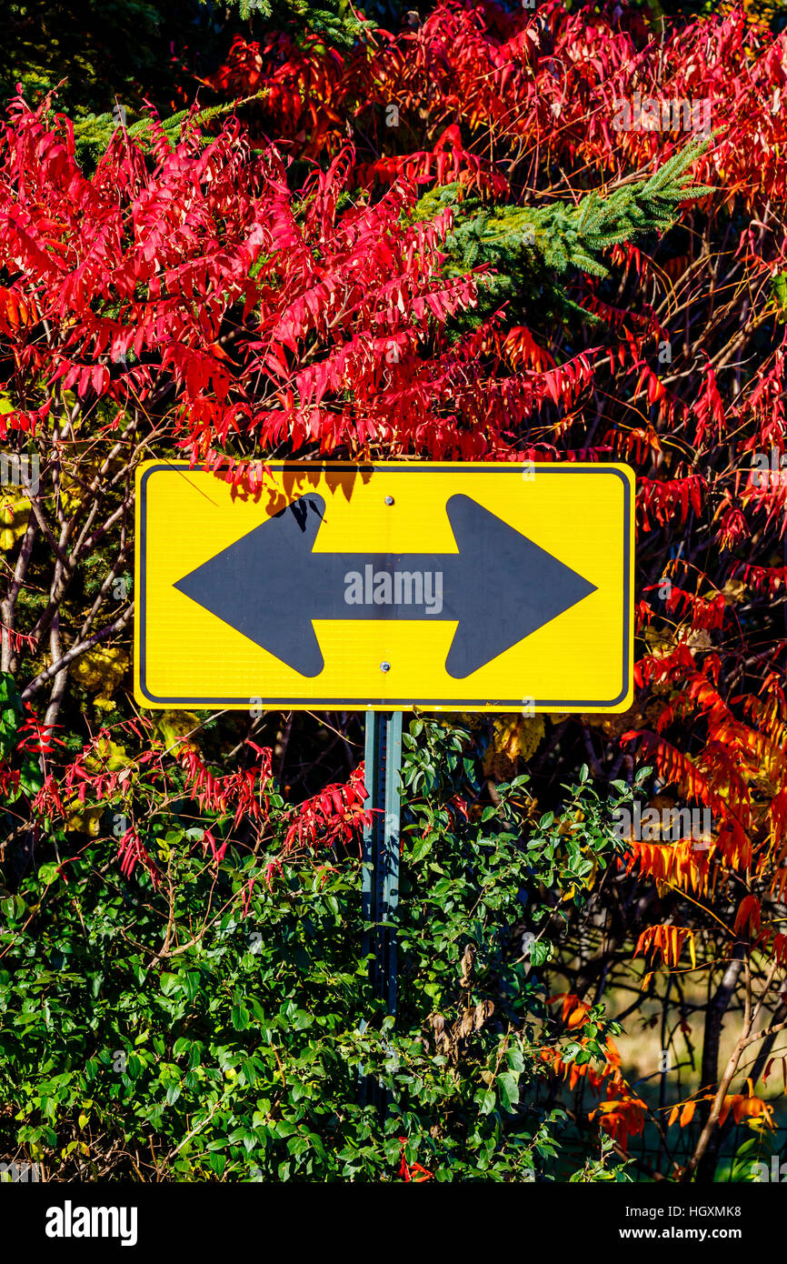 Vertical image of a road sign showing two directions Stock Photo - Alamy