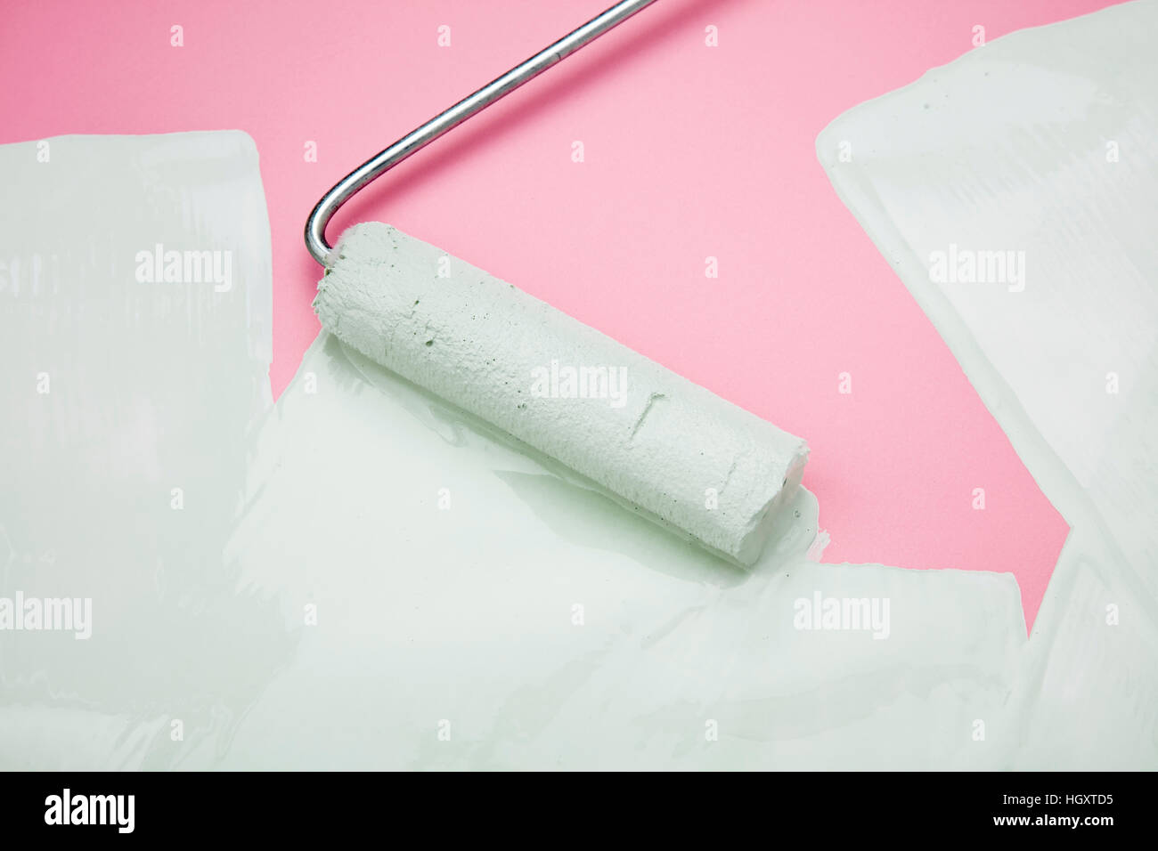 Paintroller against pink Stock Photo - Alamy