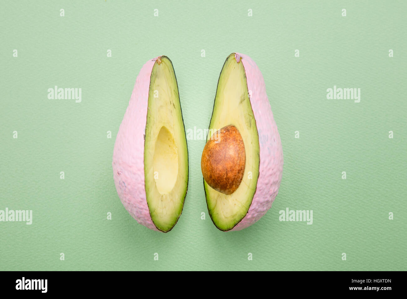Cross sections of creative pink avocado Stock Photo - Alamy