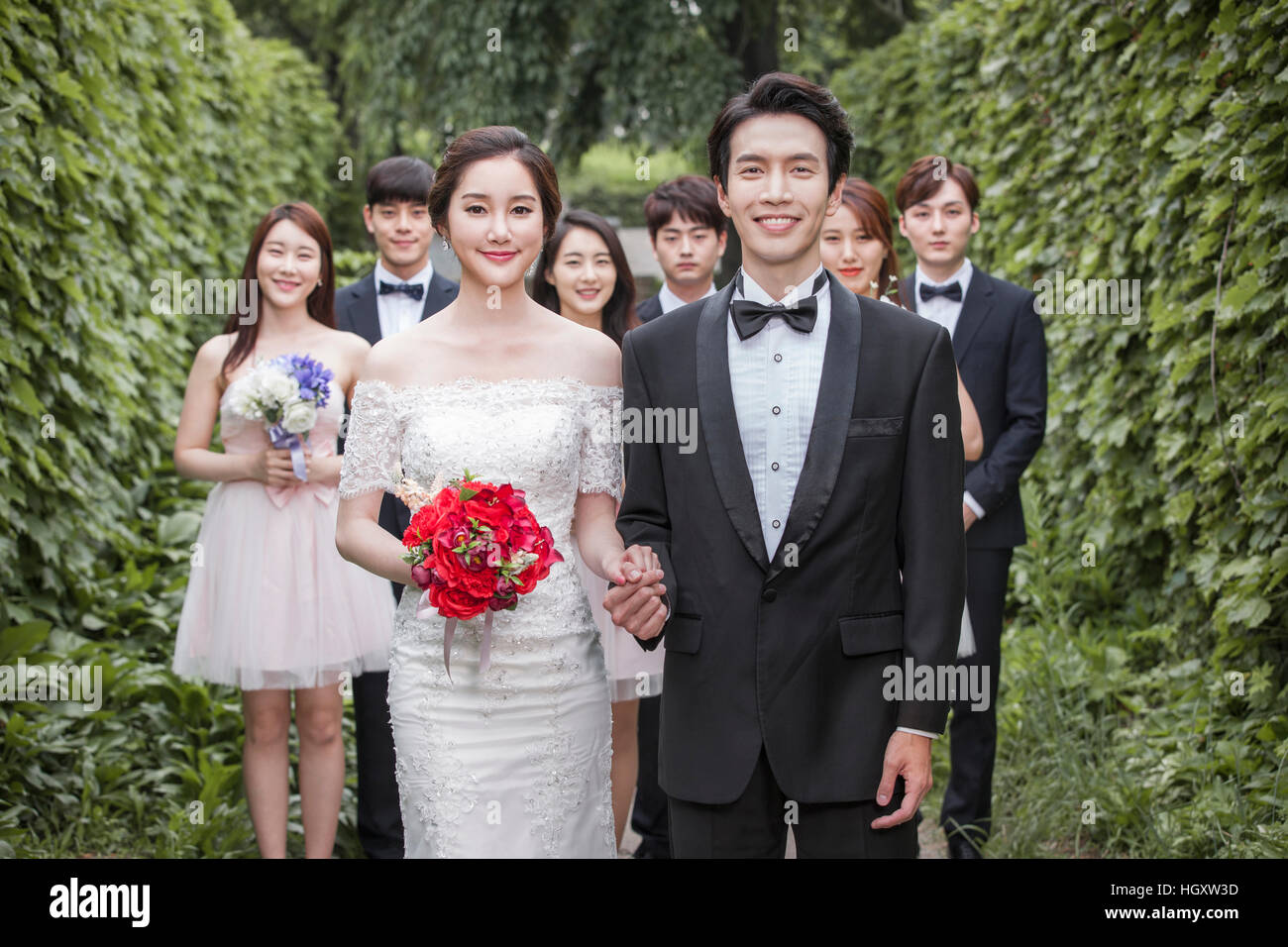 Smiling wedding couple and their friends Stock Photo - Alamy