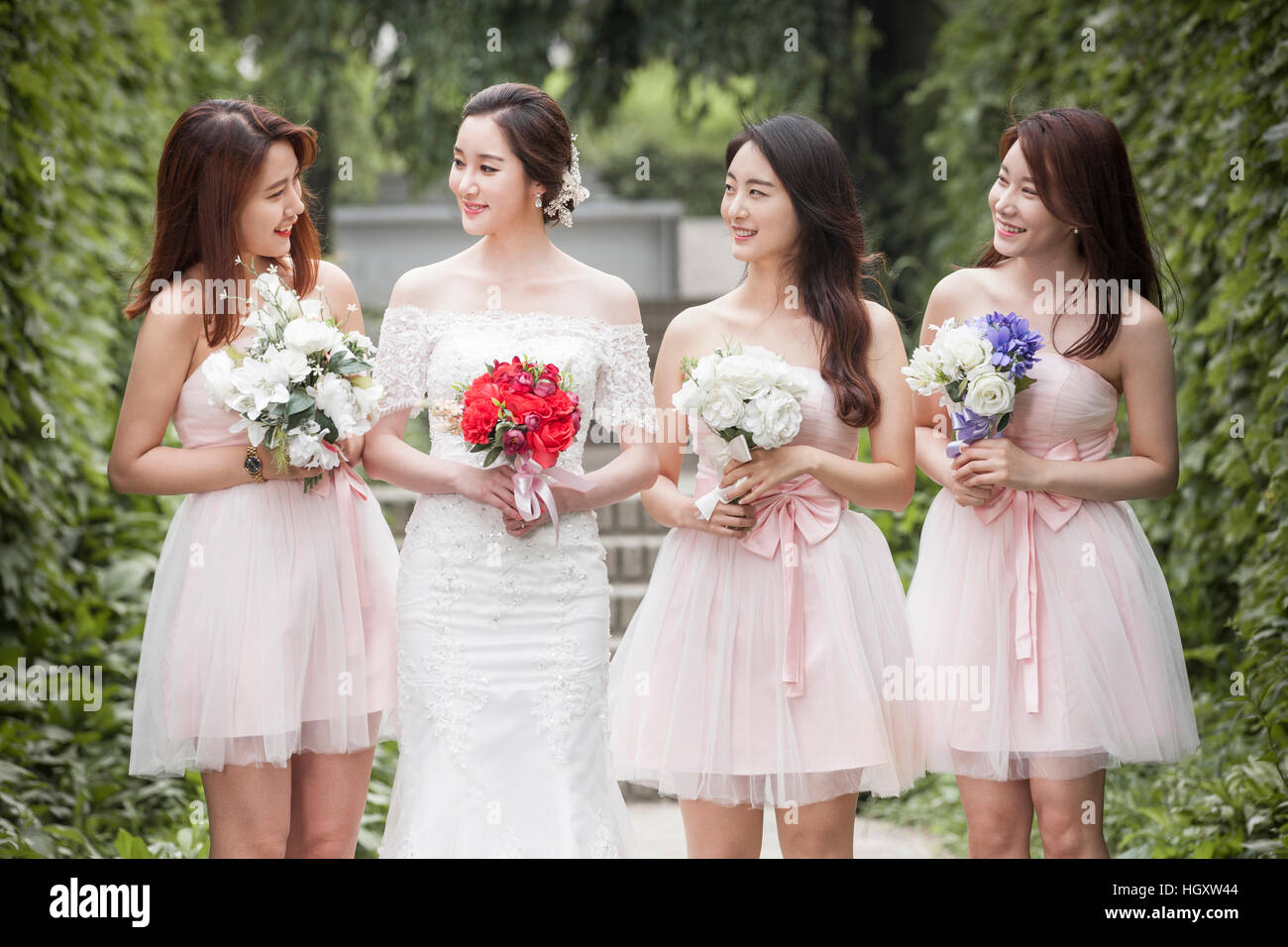 Smiling bride and her friends Stock Photo - Alamy