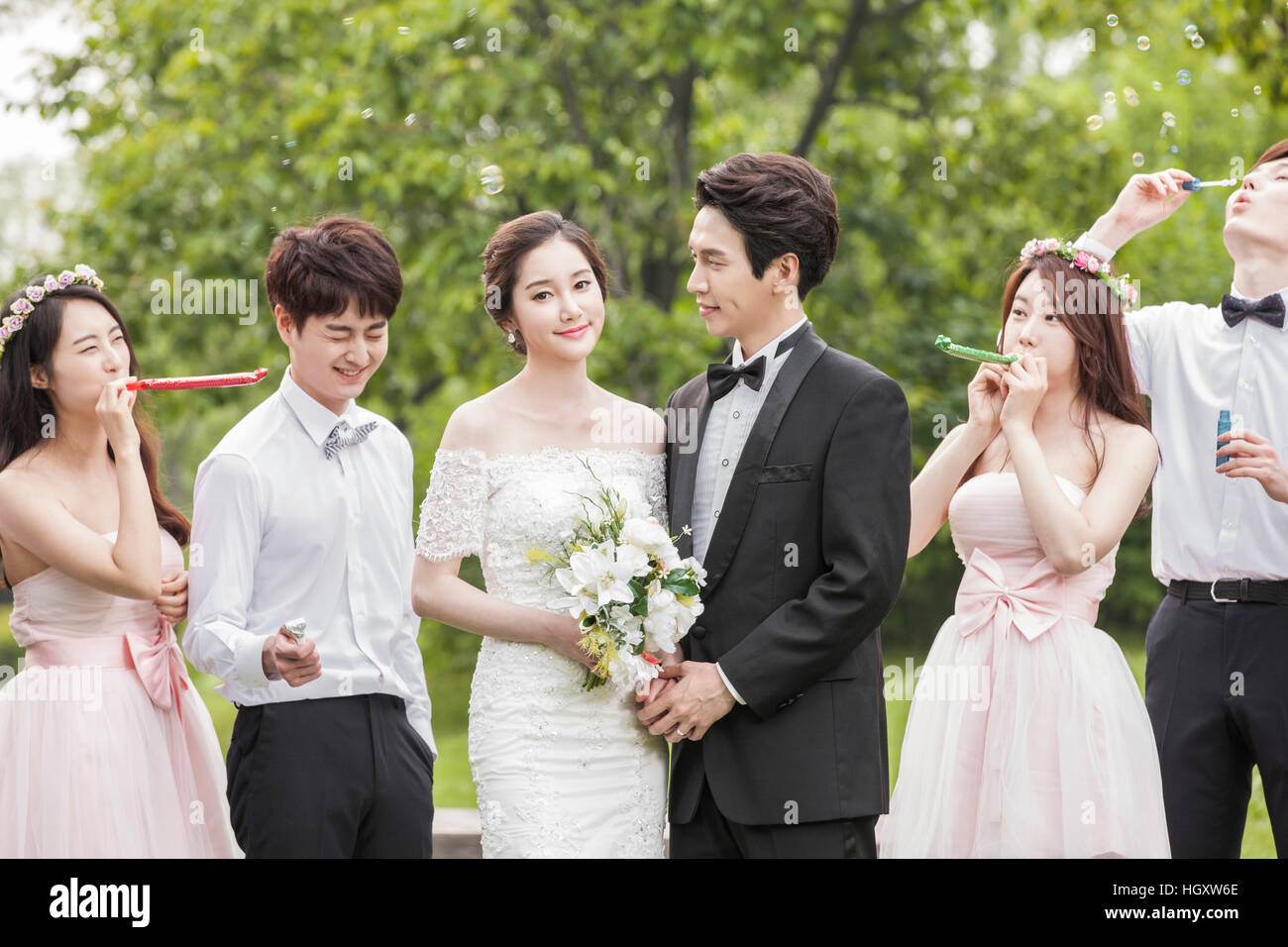 Smiling wedding couple and their friends Stock Photo - Alamy