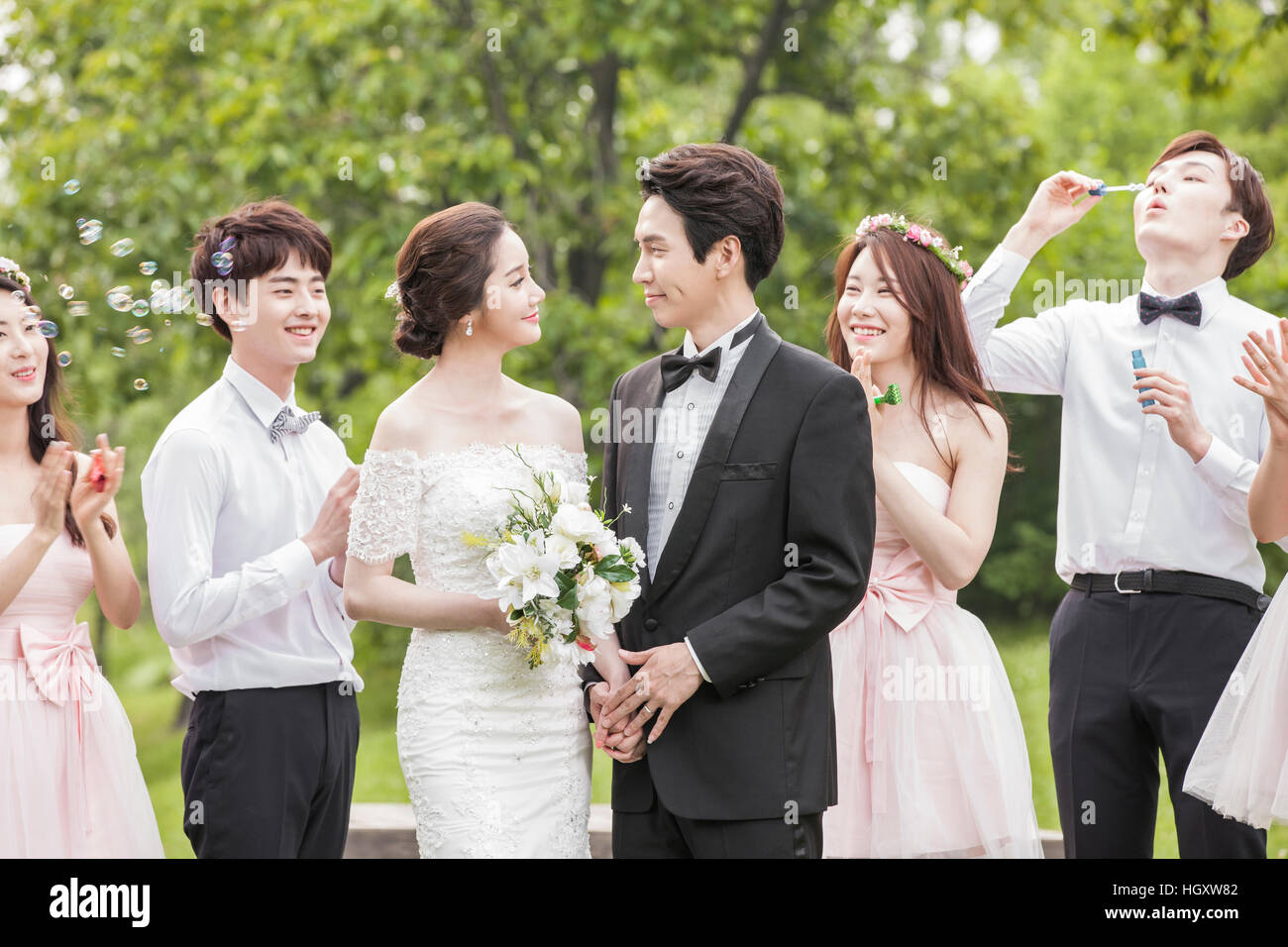 Romantic wedding couple and their friends Stock Photo - Alamy