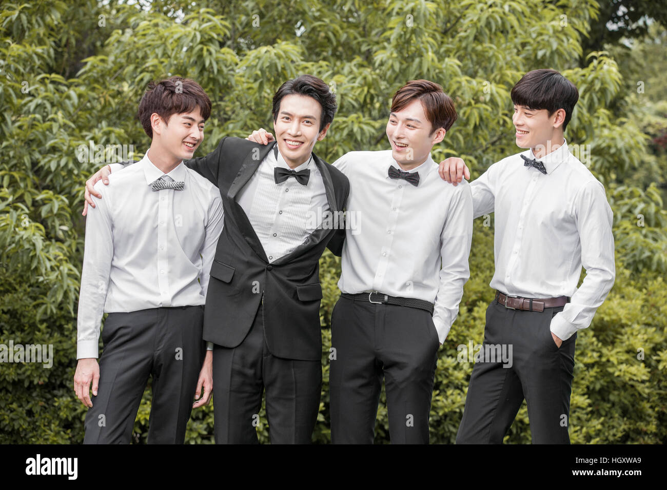 Smiling groom and his friends Stock Photo - Alamy