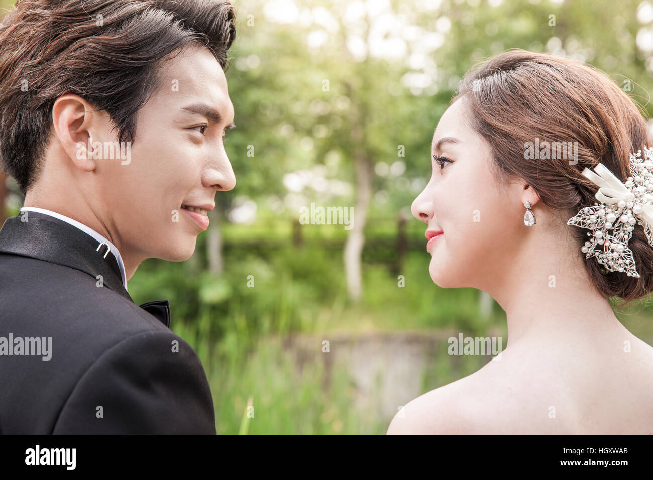Portrait of groom and bride smiling at each other Stock Photo - Alamy