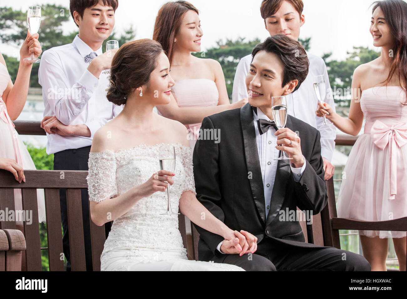 Romantic wedding couple and their friends Stock Photo - Alamy