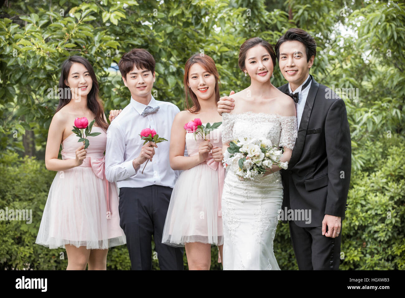 Smiling wedding couple and their friends Stock Photo - Alamy