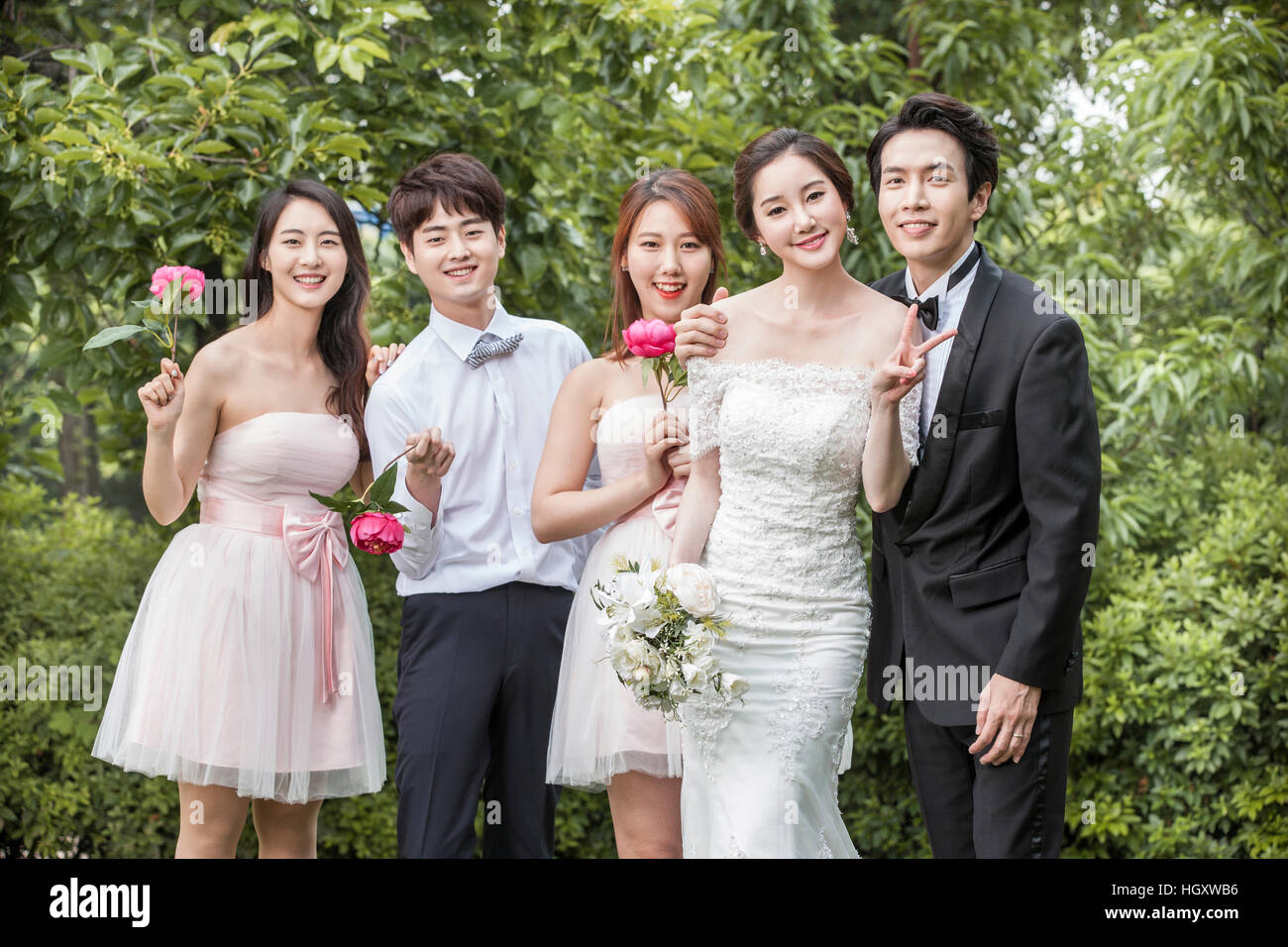 Smiling wedding couple and their friends Stock Photo - Alamy